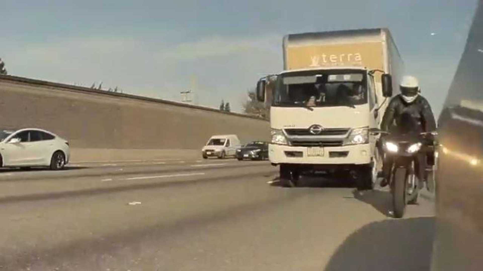 Watch This Motorcyclist Kick A Moving Tesla Model 3