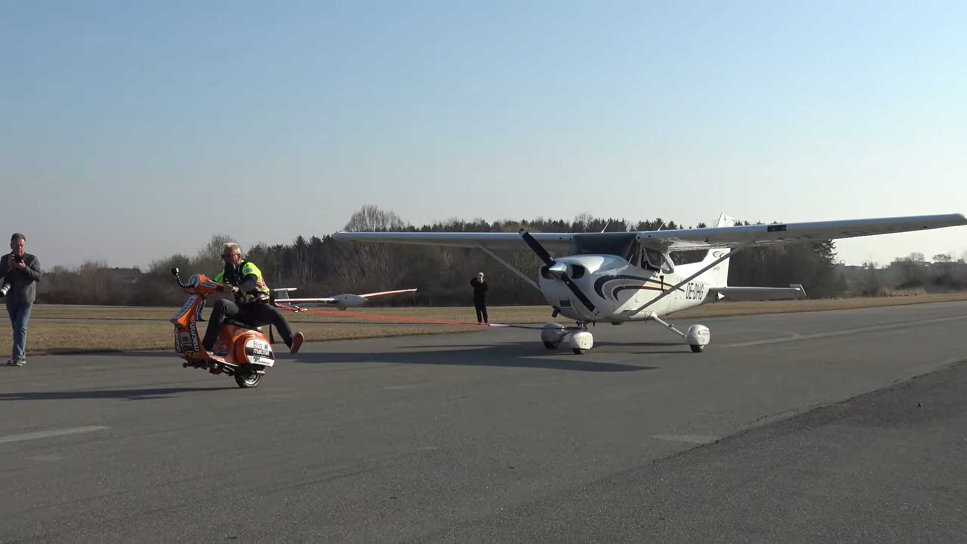 Watch This Vespa Stuntman Pull A Plane Down A Runway With His Scooter